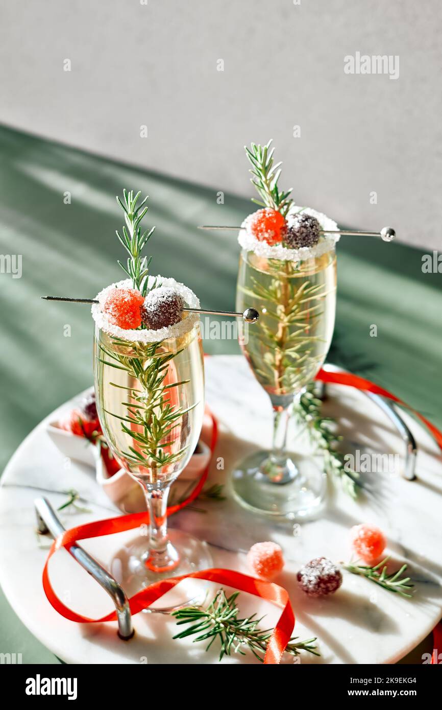 Christmas cocktail with sparkling wine, rosmary and cherry. Winter xmas ...