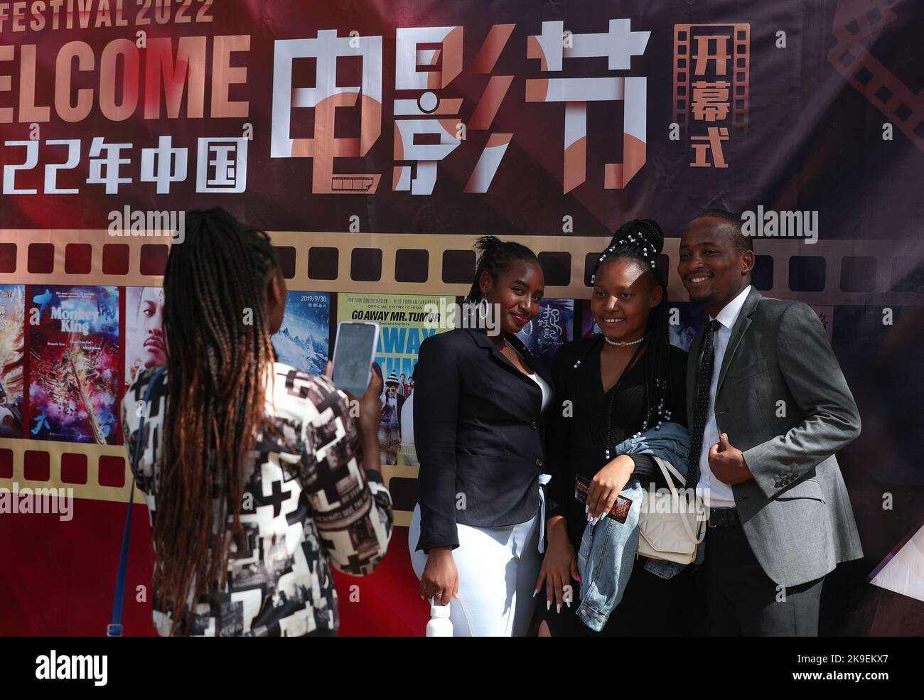 Nairobi, Kenya. 27th Oct, 2022. Visitors pose for a photo in front of a poster of the 2022 ...