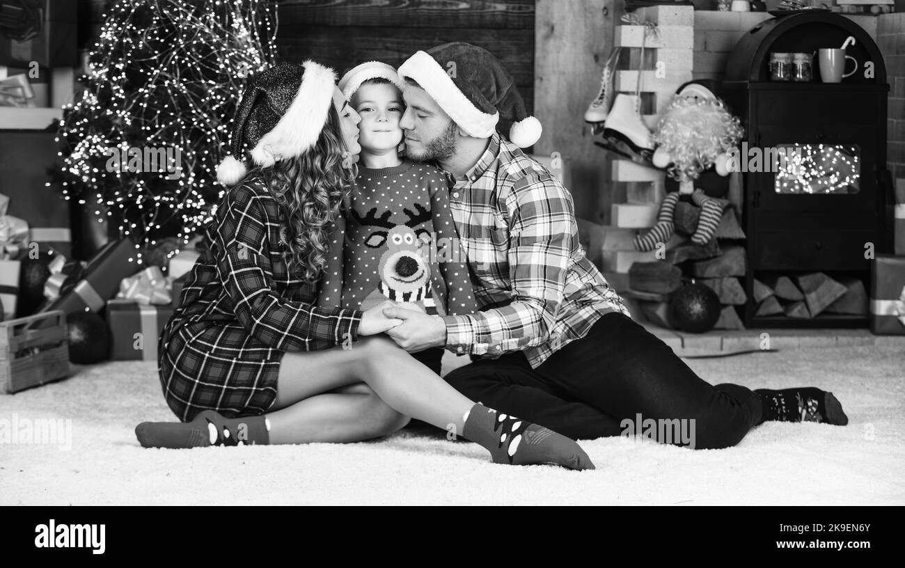 Idyllic moment. Father and mother with cute son christmas tree ...