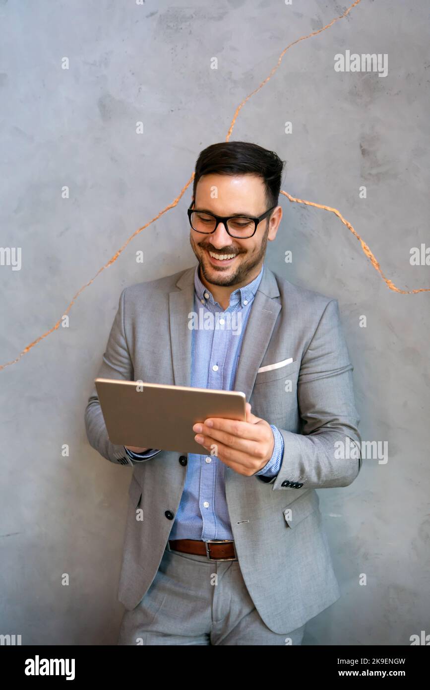 Portrait of young business man working on digital tablet Stock Photo ...