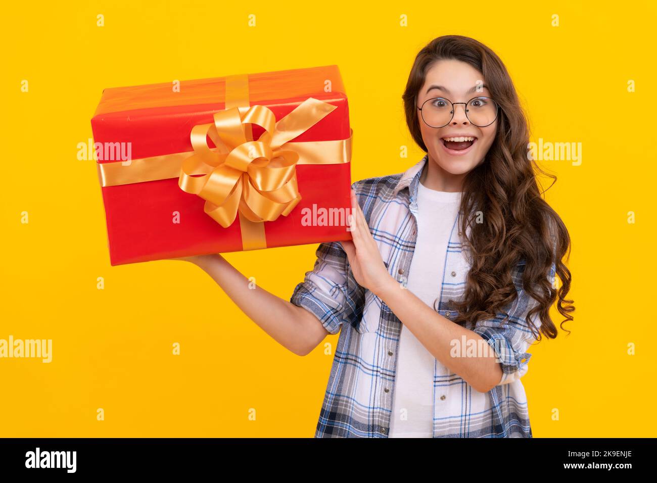 amazed teen child holding box of present. teen child with present ...