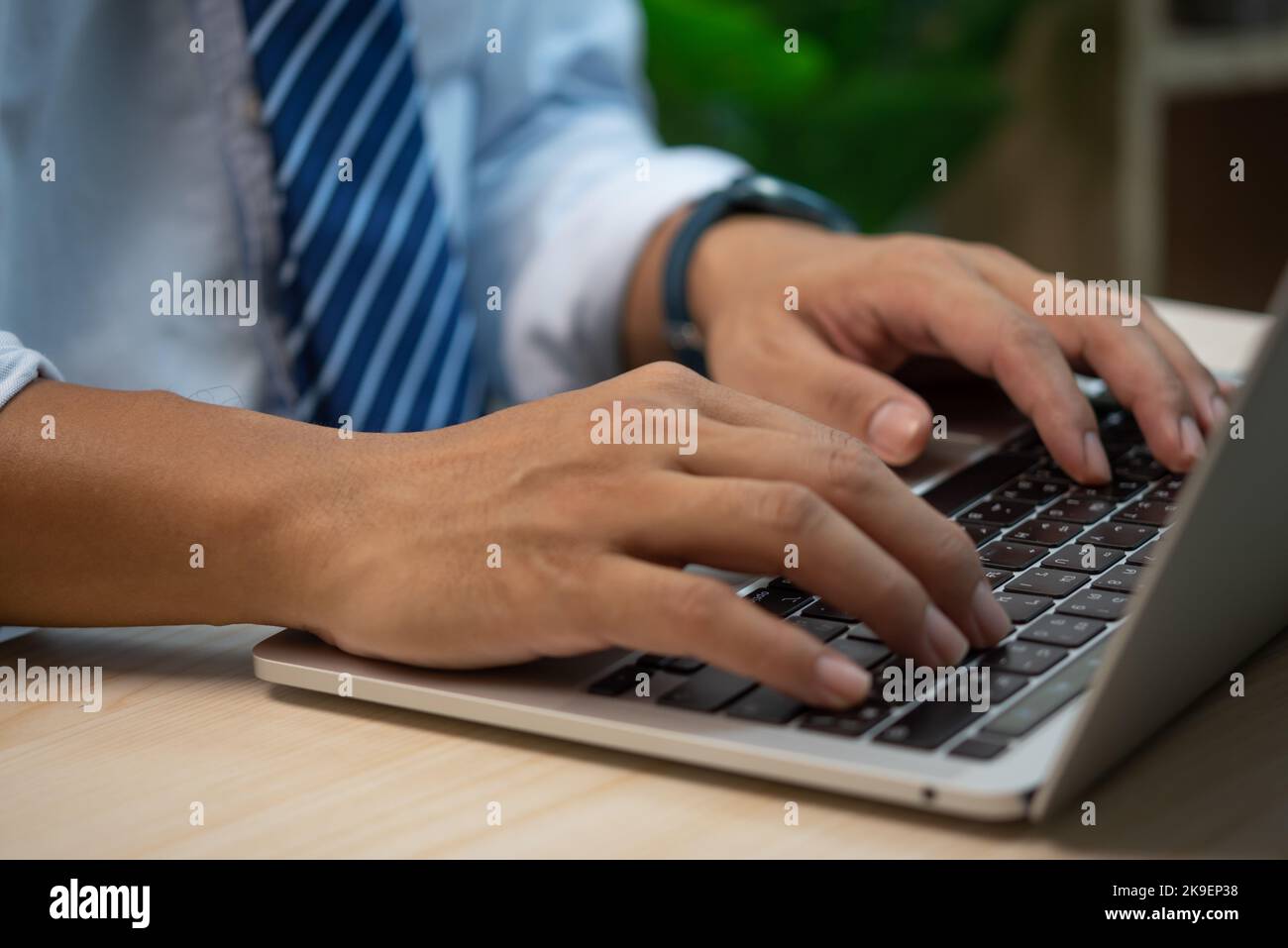 male hands typing on keyboard laptop at the office.search information ...