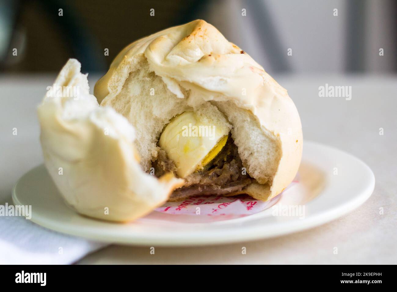 A baked bun locally called siopao, which is a popular Filipino snack at ...