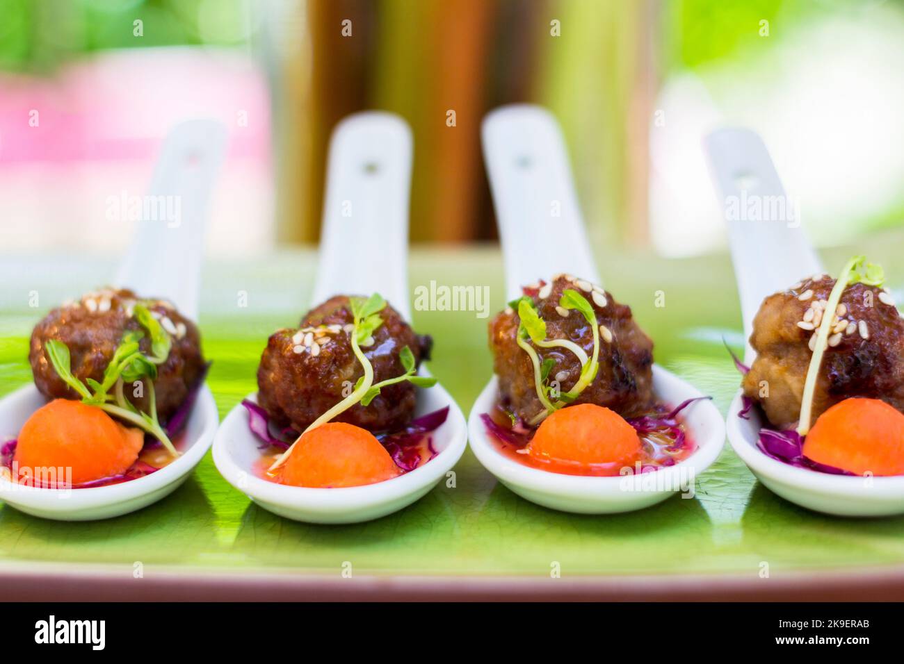 Sweet and sour meat balls on ceramic spoons at a hotel buffet in Cebu ...