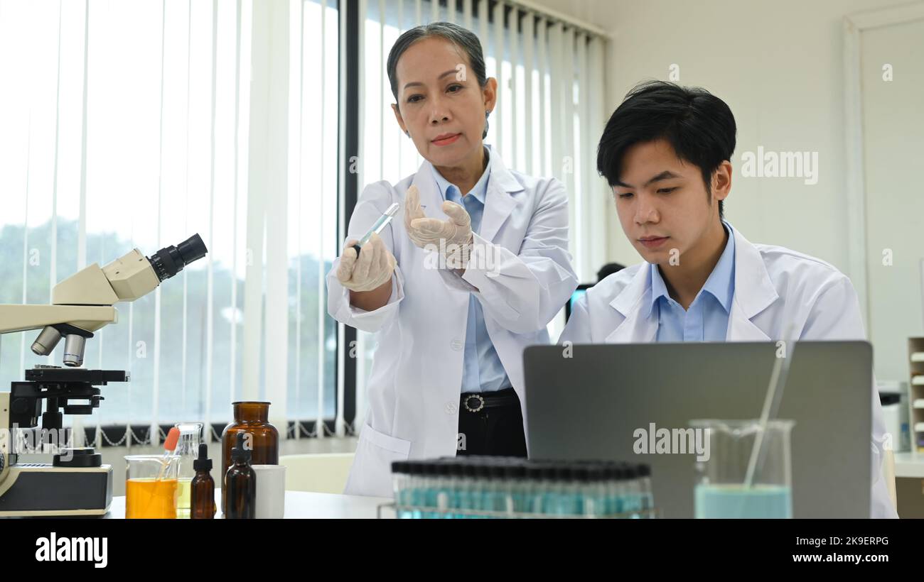 Experienced scientists team conducting experiments, consisting of ...