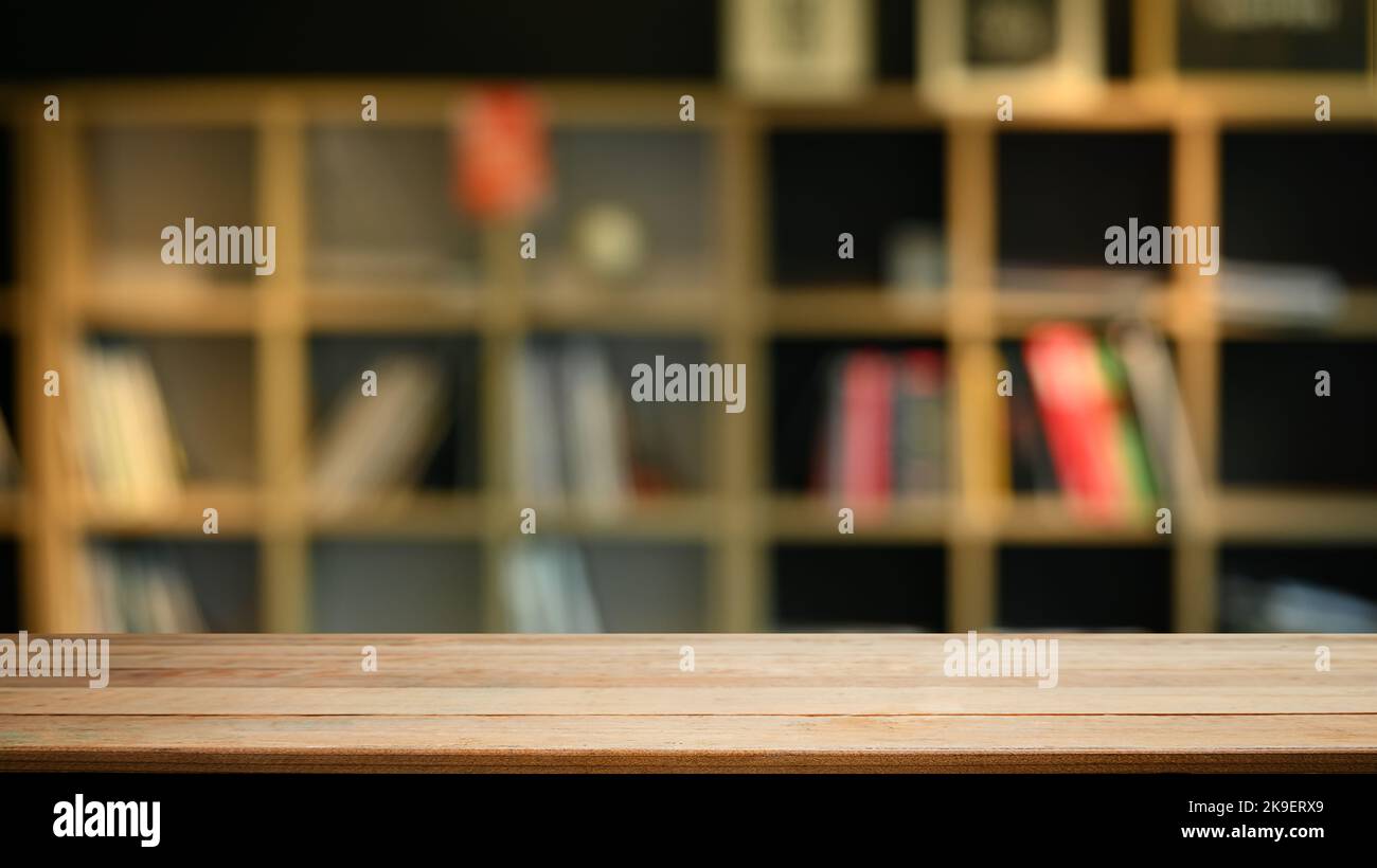 Empty wooden against blurred bookshelf background. Copy space for your ...