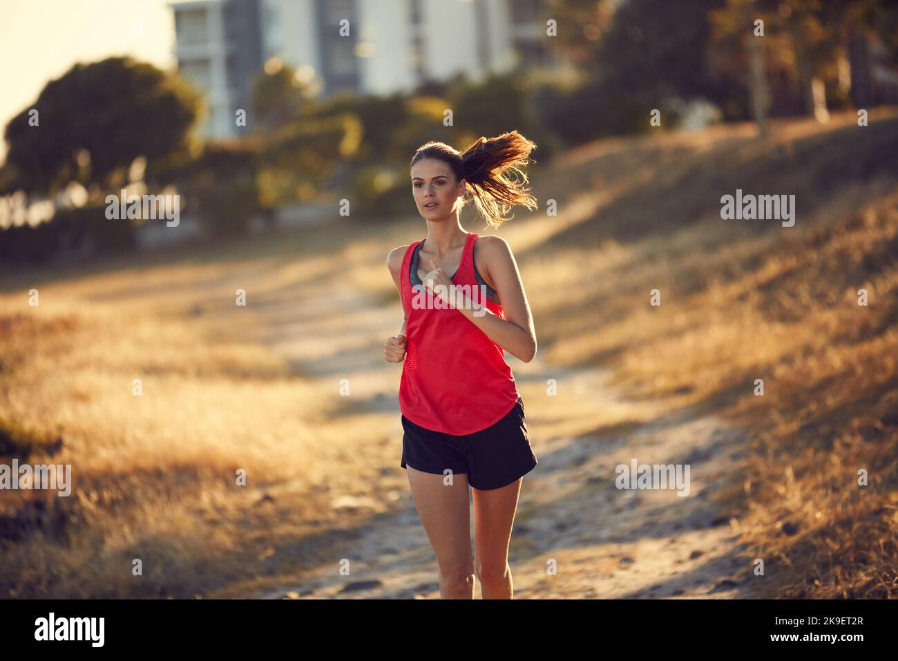 She gives it her all in every run. a sporty young woman exercising ...