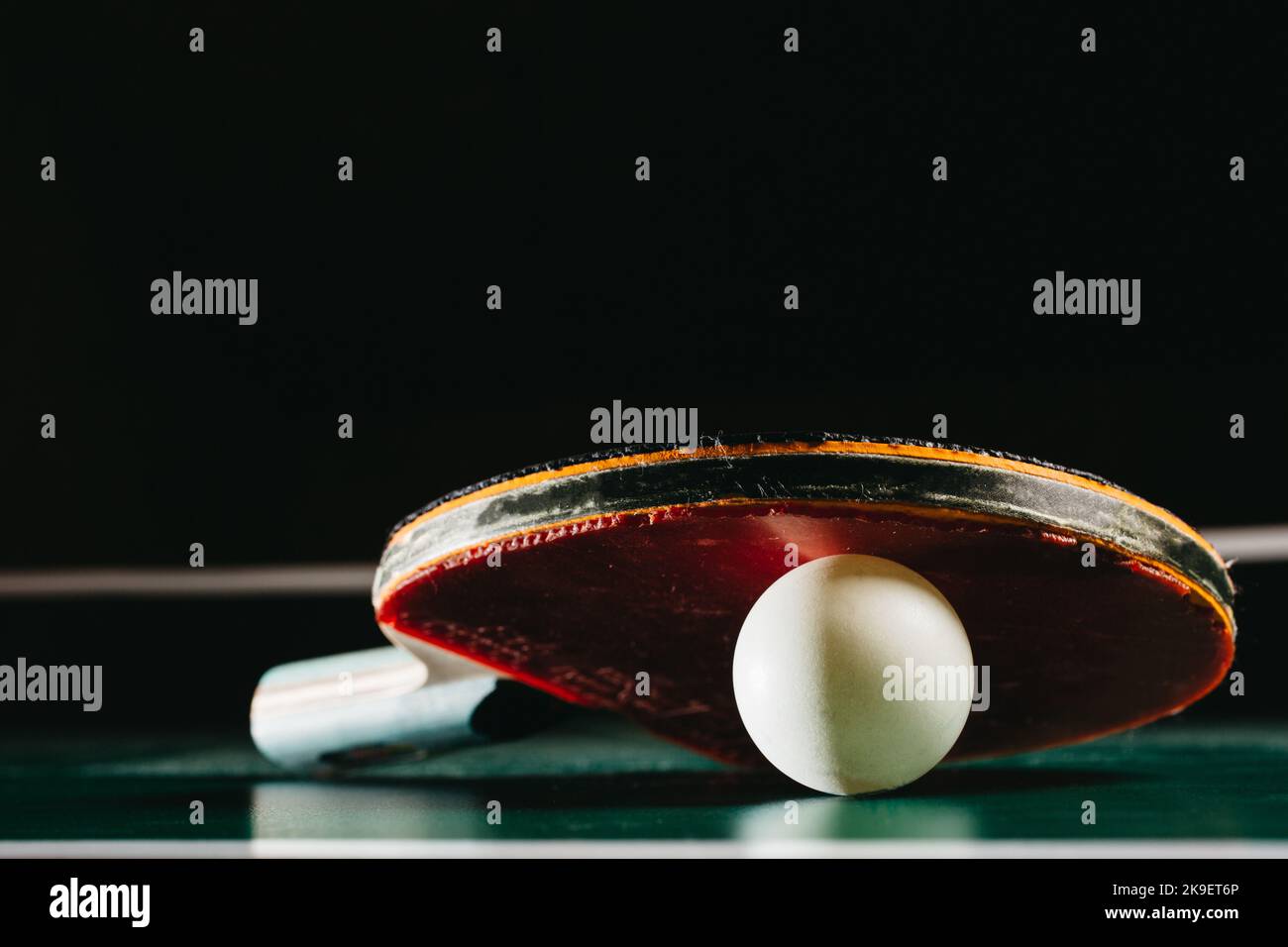 Ping pong racket leaning on ping pong ball Stock Photo - Alamy