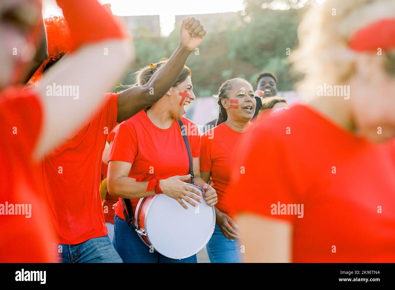 Delighted multiracial fans celebrating win after match Stock Photo - Alamy