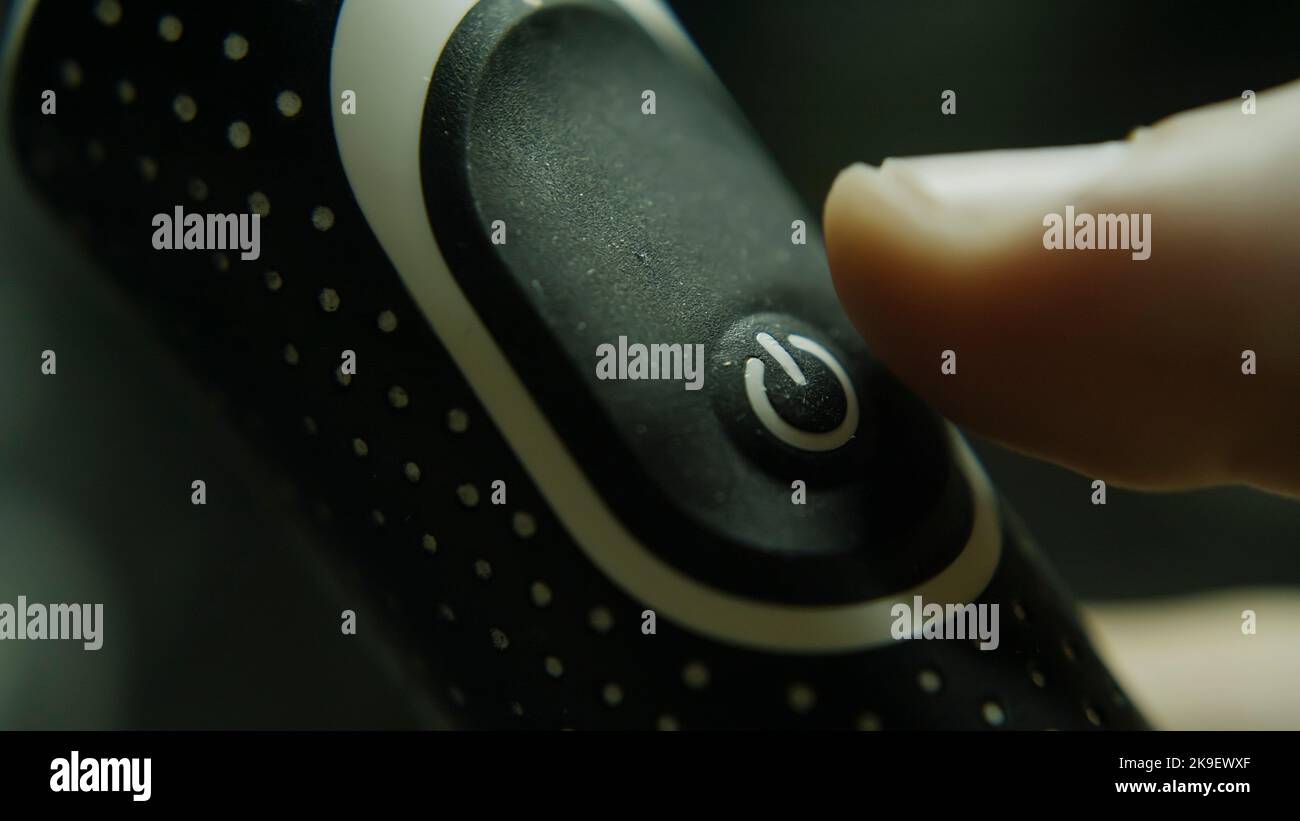 Power button close-up, a finger pressing to power button, energy and ... Power button close-up, a finger pressing to power button, energy and ...