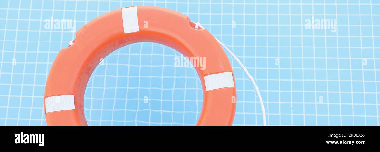 Red safety equipment floating on swimming pool to rescue people from ...