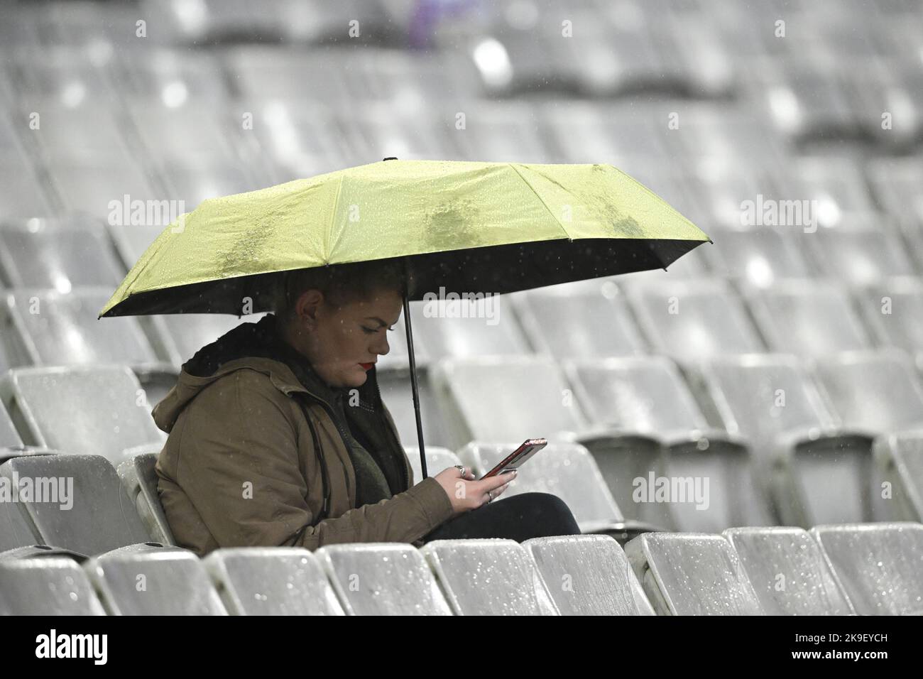 A spectator takes cover from the rain during the T20 World Cup Super 12 ...