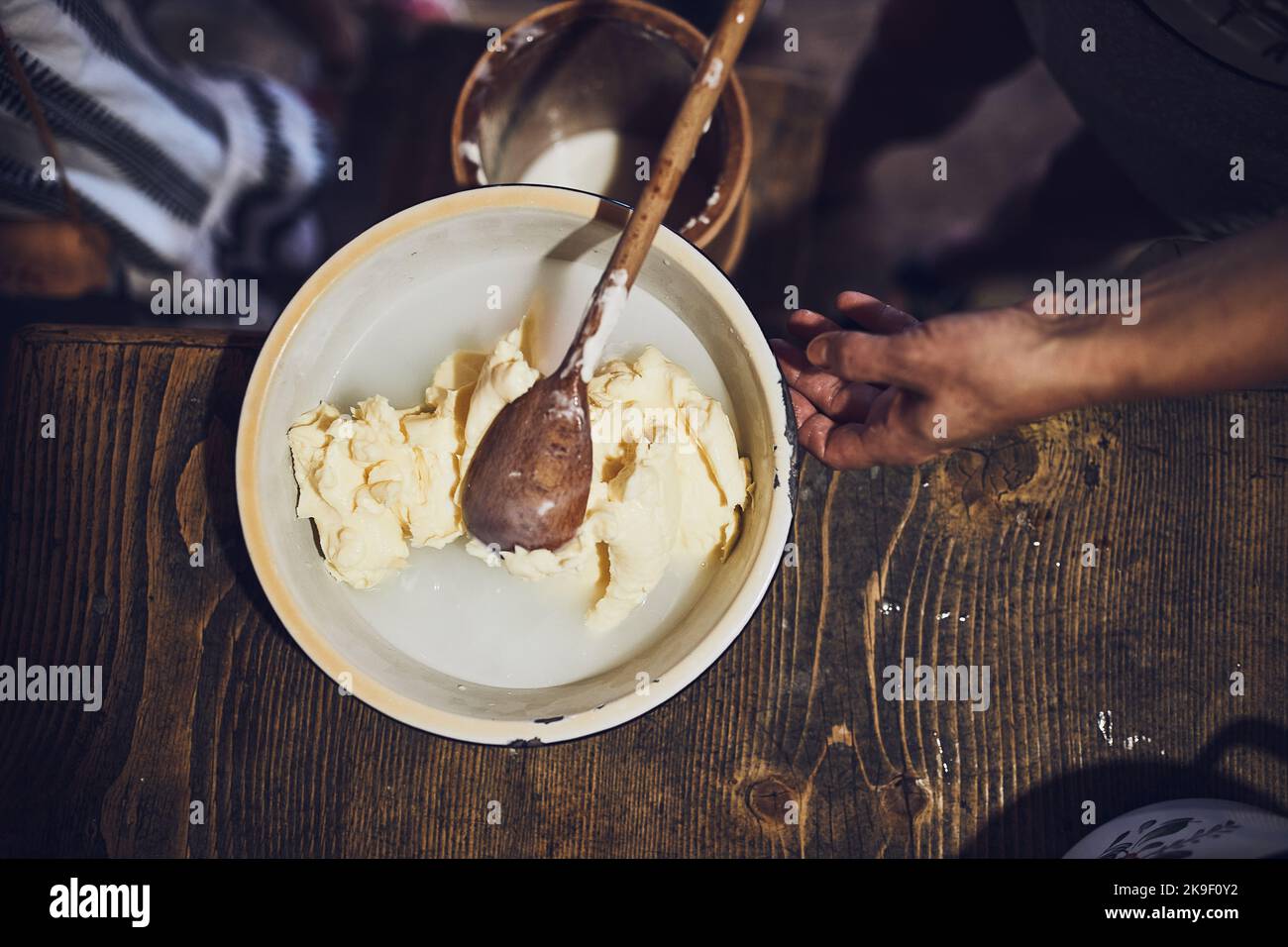 Female making butter with butter churn. Old traditional method making ...