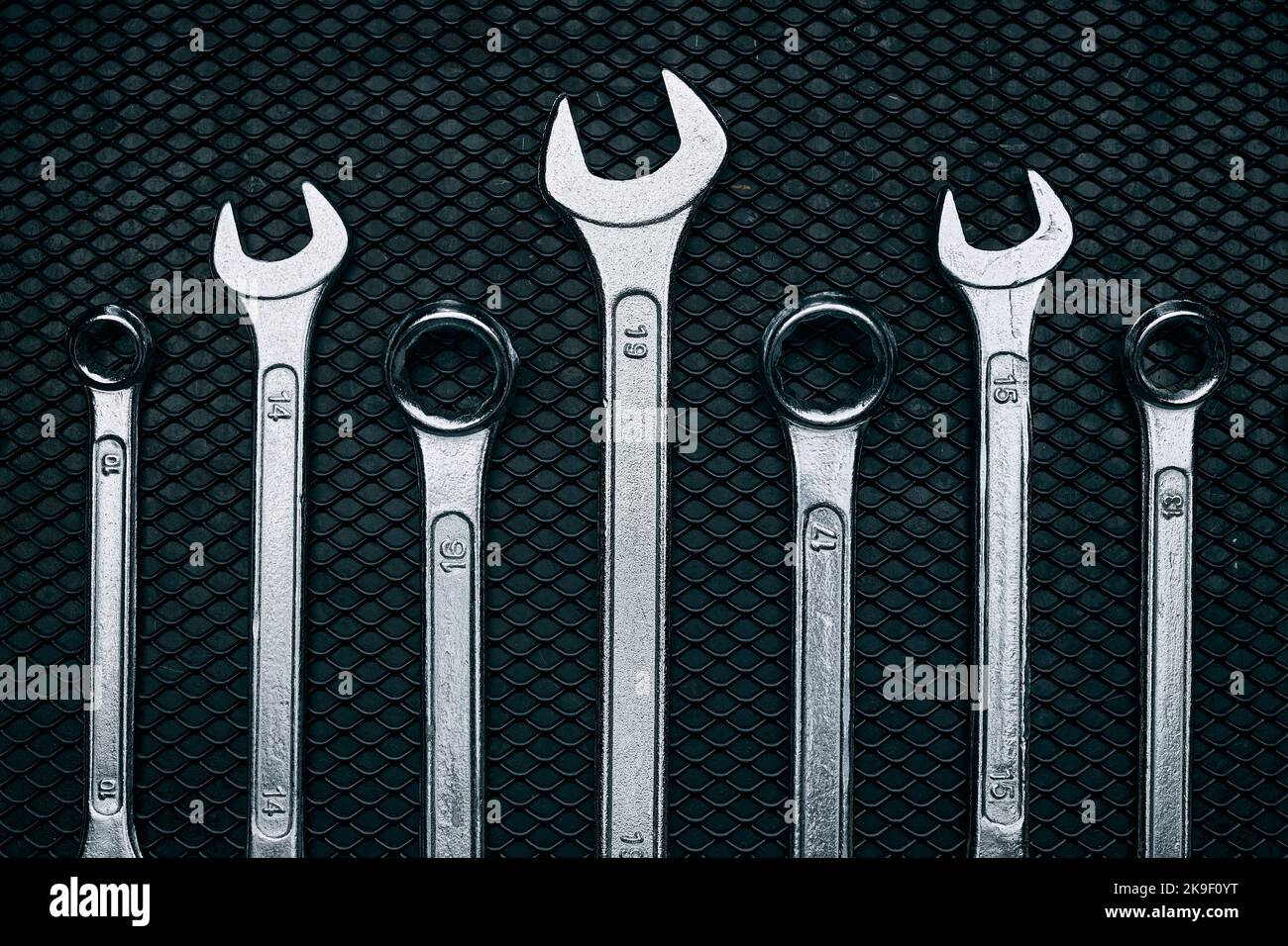 Set of chrome wrenches on steel surface. Mechanic tools for maintenance ...