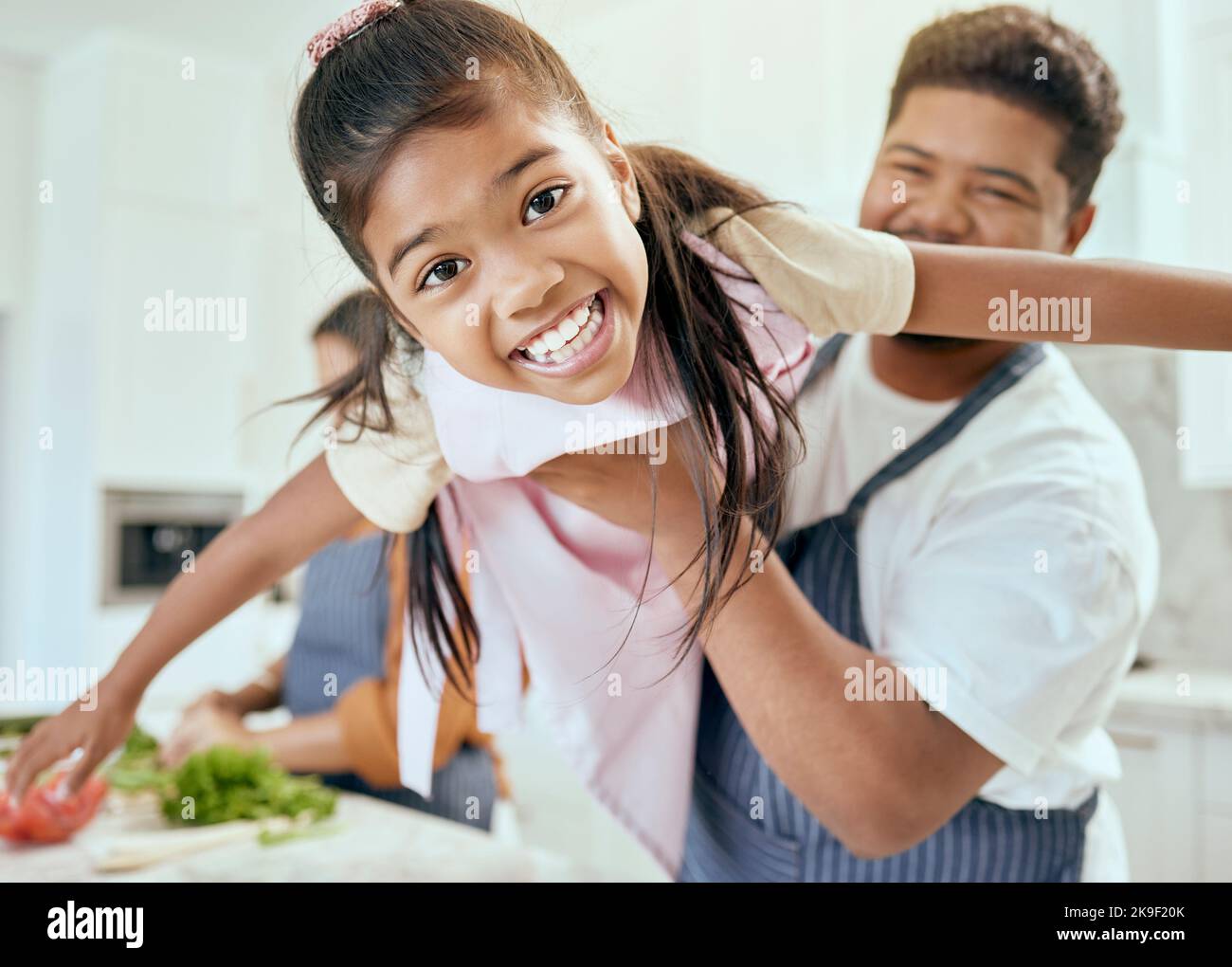 Family, kitchen and cooking together, smile in portrait and father lift ...