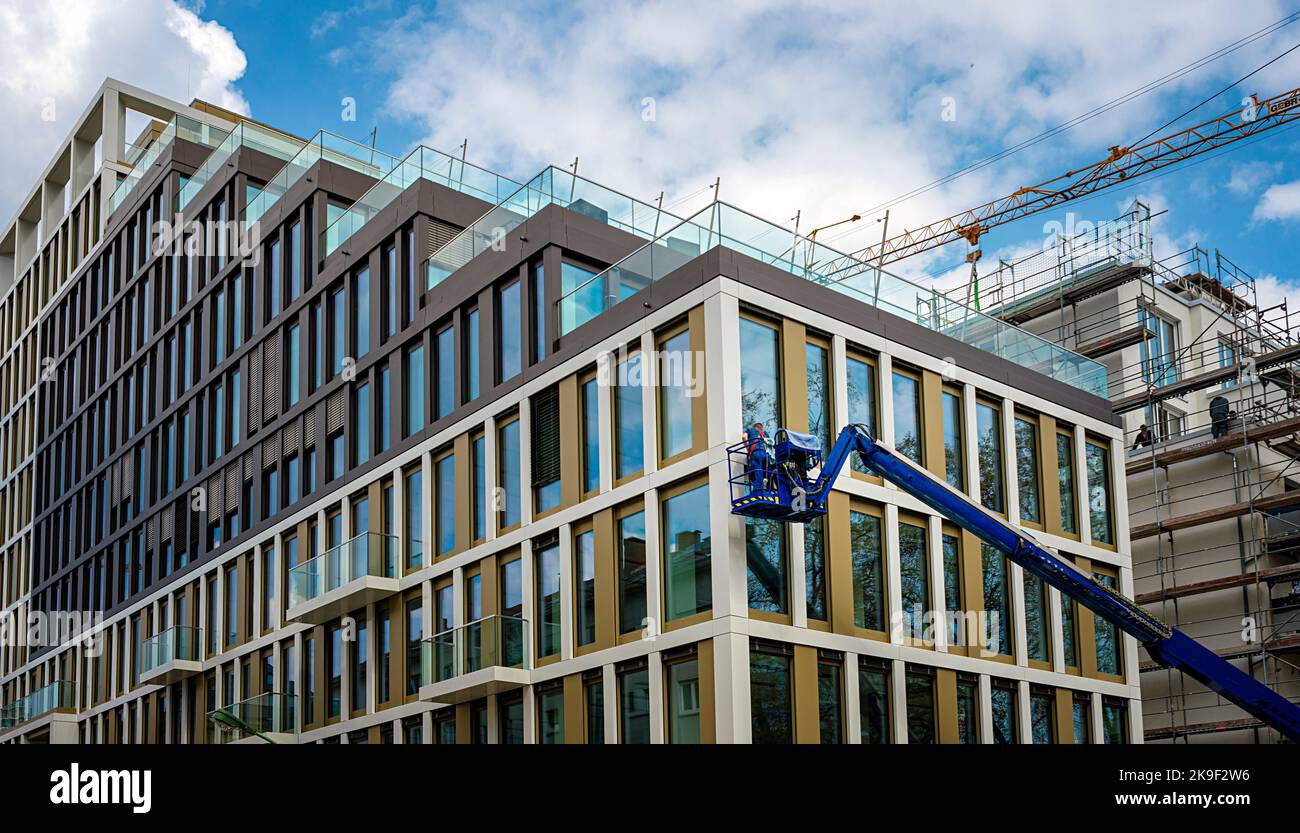 Workmen With Lifting Platform Work On The Facade Of A High-rise ...