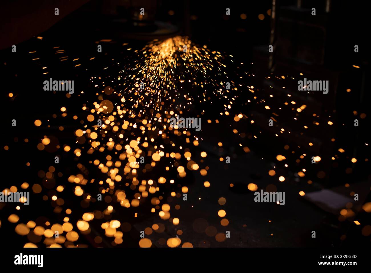 Sparks from grinding metal. Bright lights in dark. Cutting steel. Metal ...