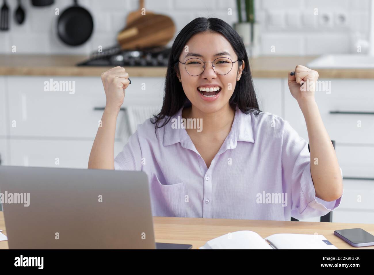 Portrait of excited Asian student woman reading test results ...