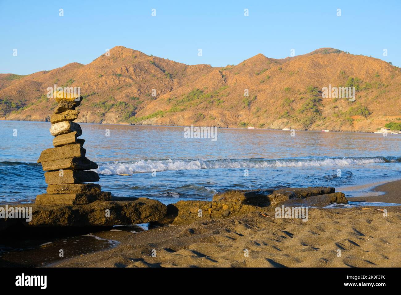 Build a tower by lining up the stones on the beach, calming down in ...