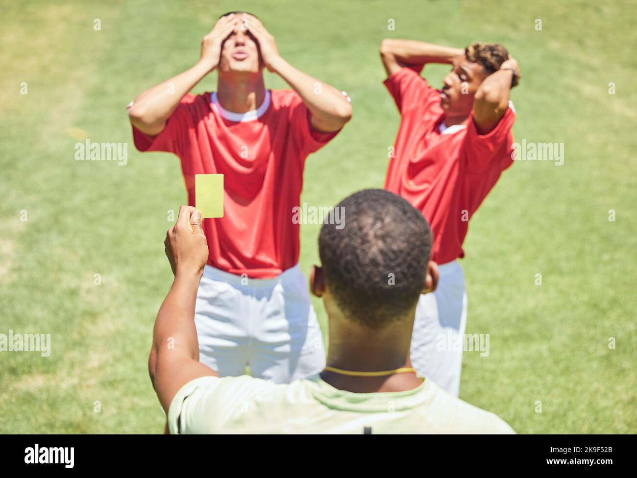Sports, soccer and referee with yellow card standing on field with ...