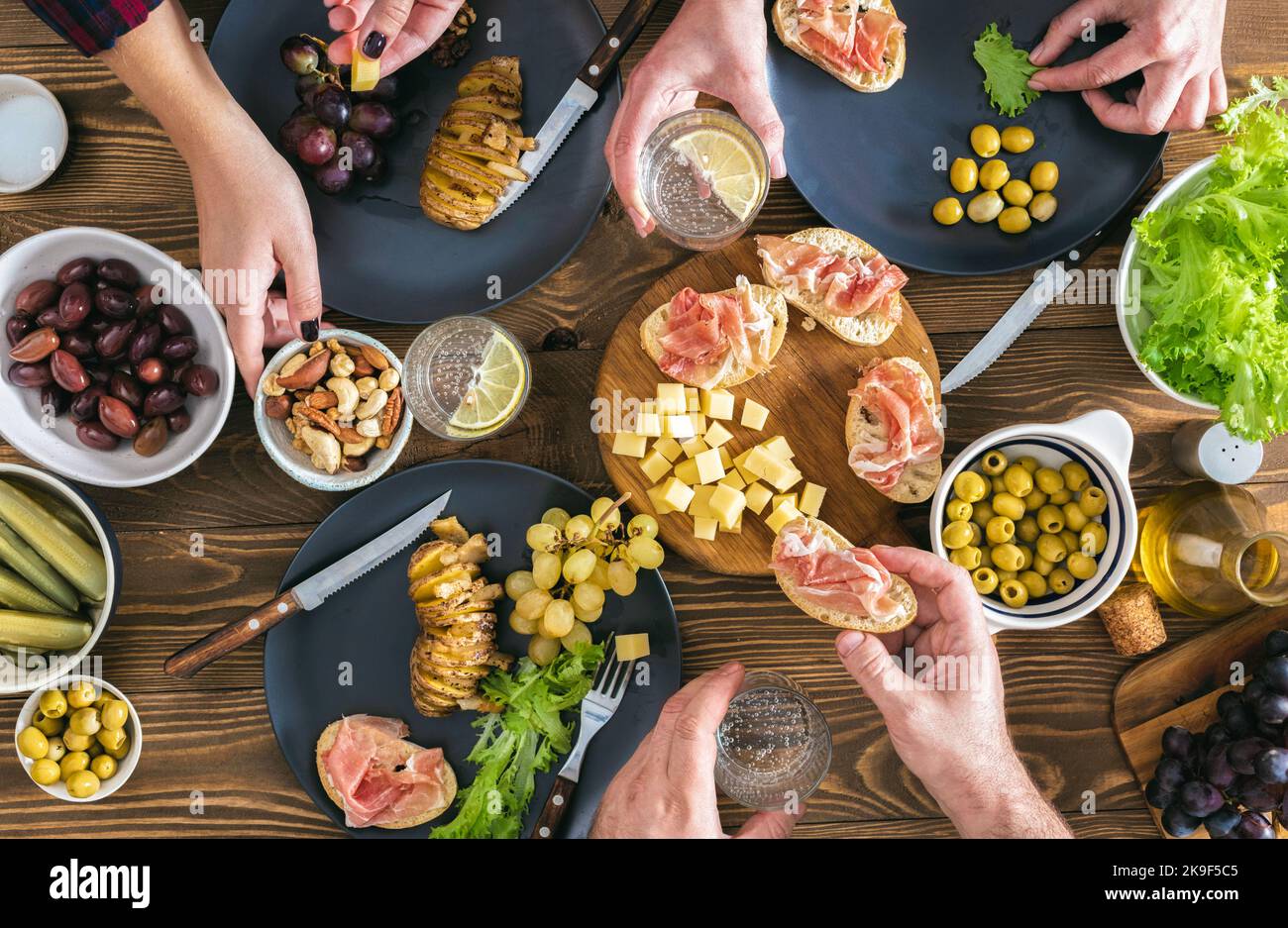 Friends having dinner table. Three people having dinner together on ...