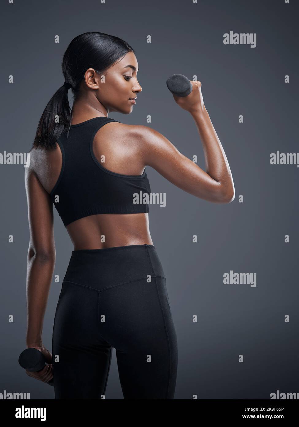 Focused on strengthening those arms. Studio shot of a sporty young ...