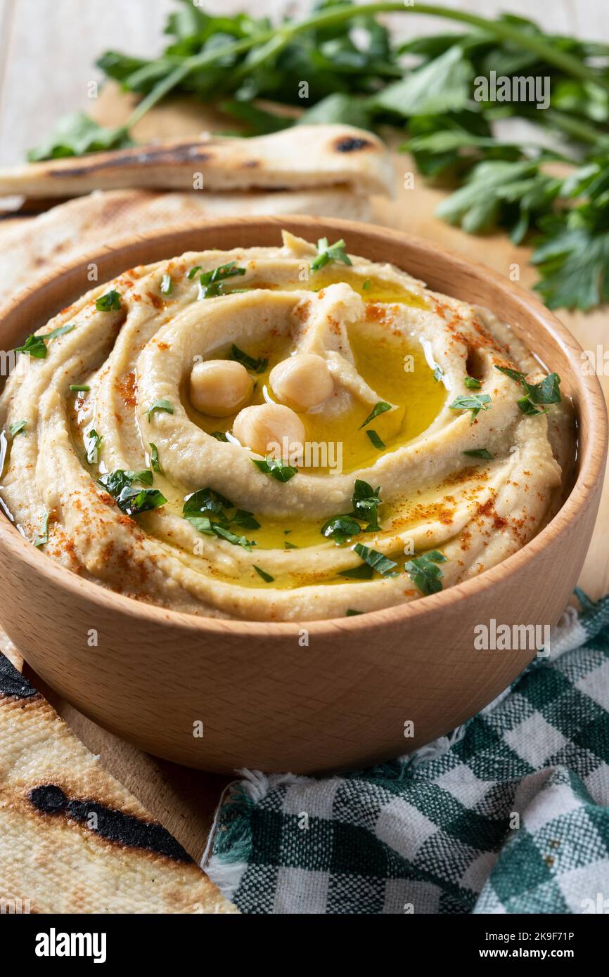 Chickpea hummus on a rustic wooden table Stock Photo - Alamy
