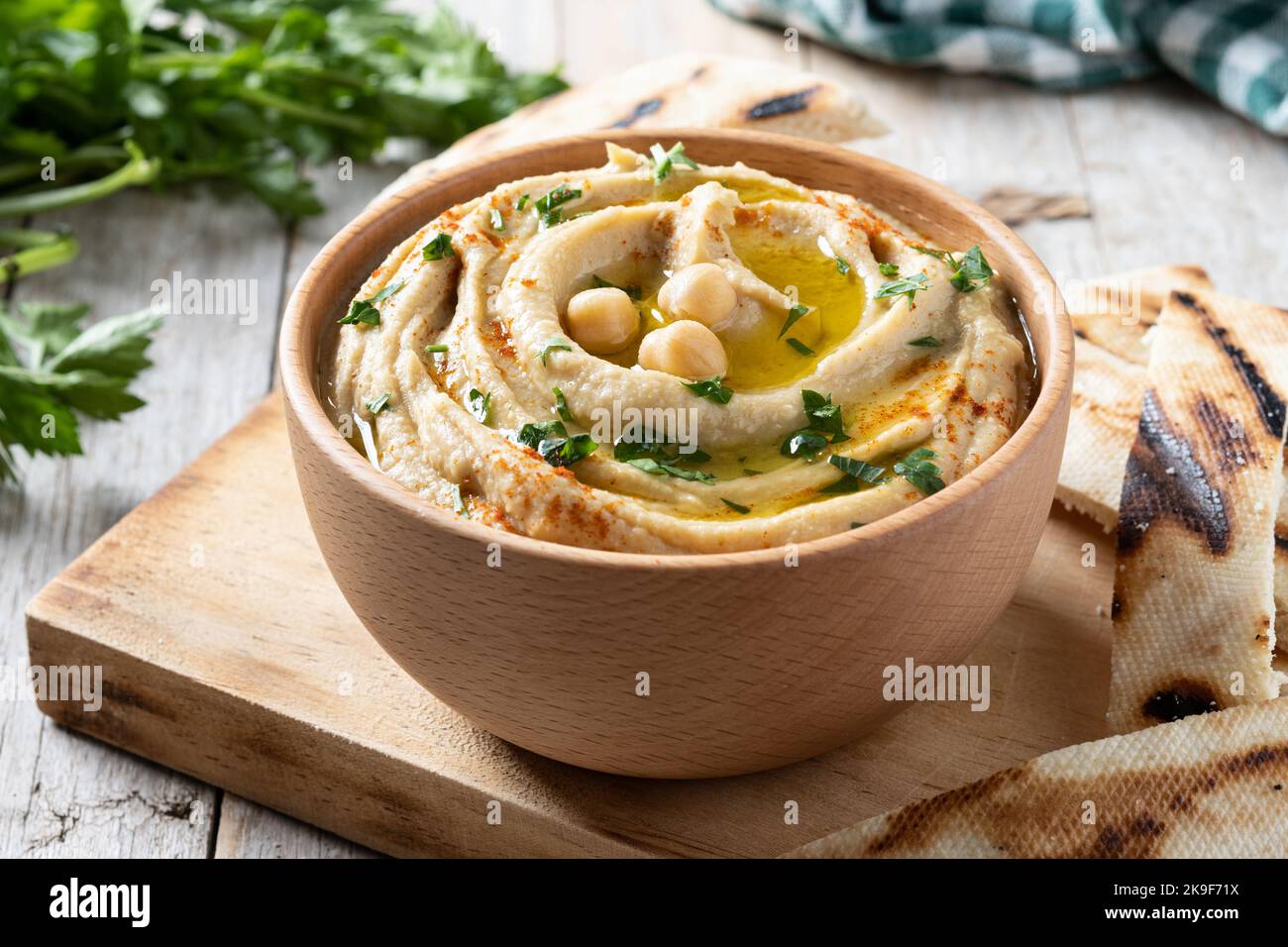 Chickpea hummus on a rustic wooden table Stock Photo - Alamy
