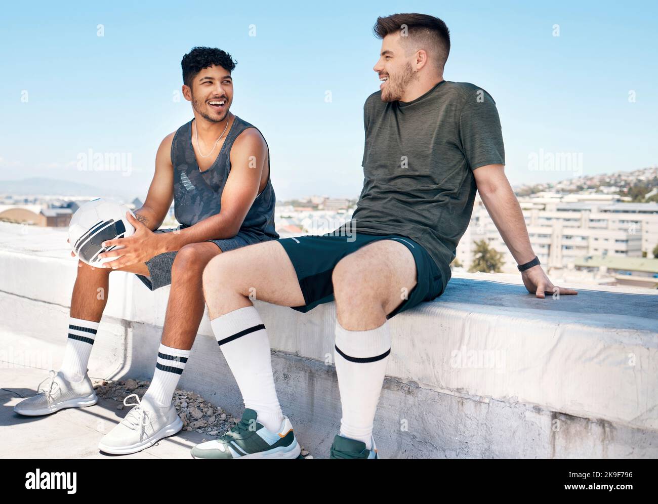 Friends, sports and talking after soccer game on rooftop for urban ...