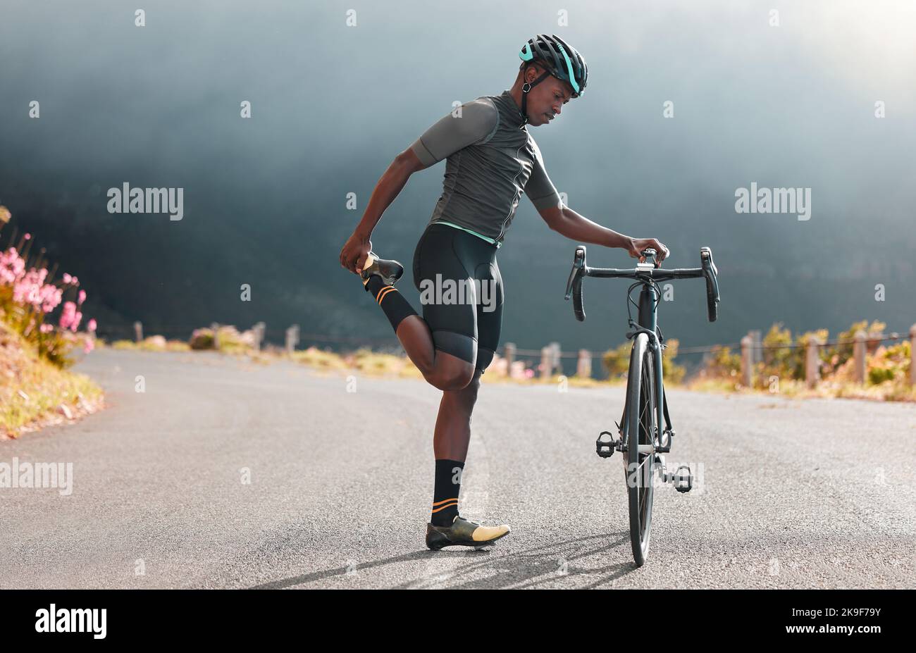 Black man, road and bicycle stretching, fitness or marathon training ...