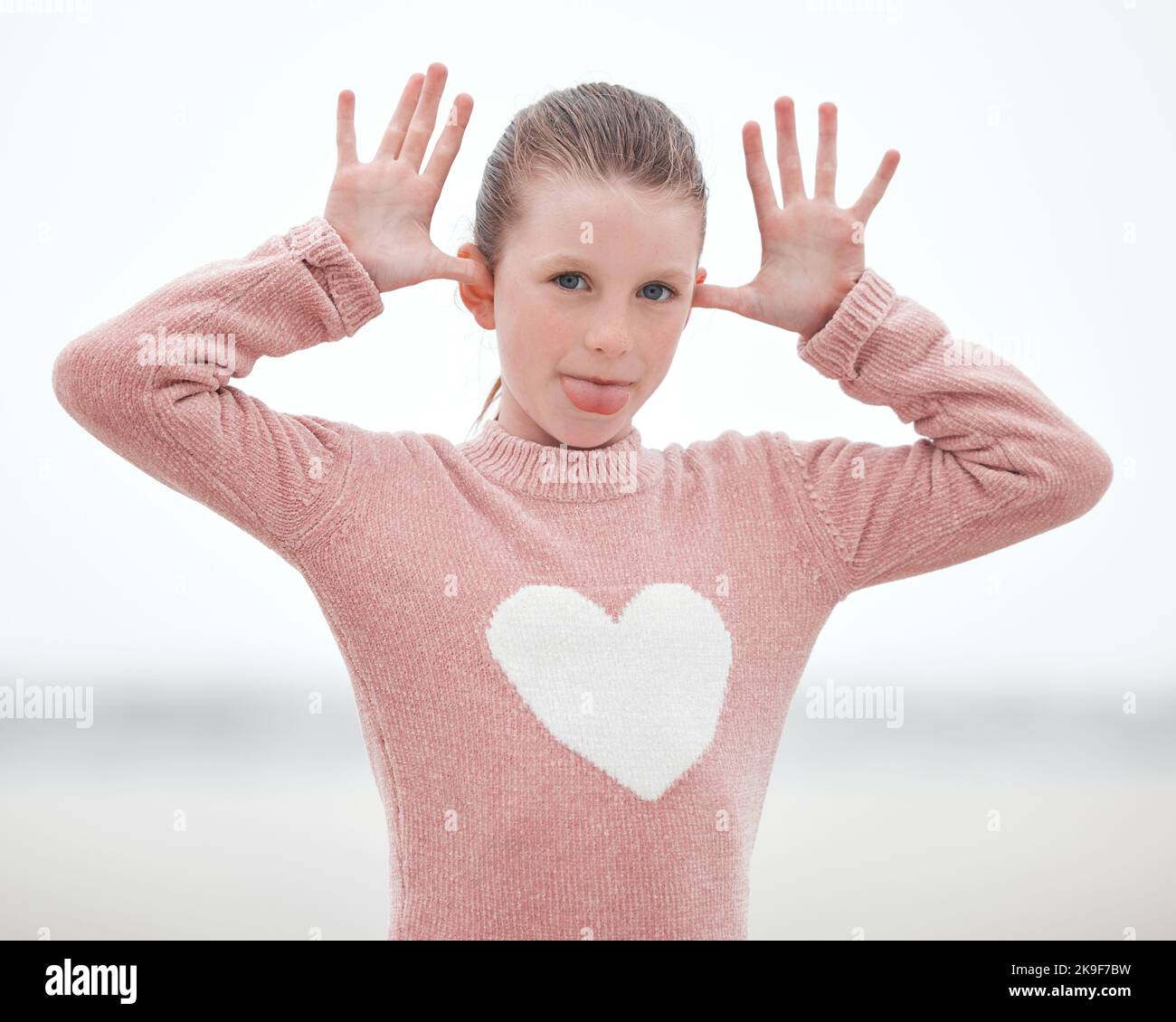 Girl, funny face and tongue for comic emoji with child on vacation ...