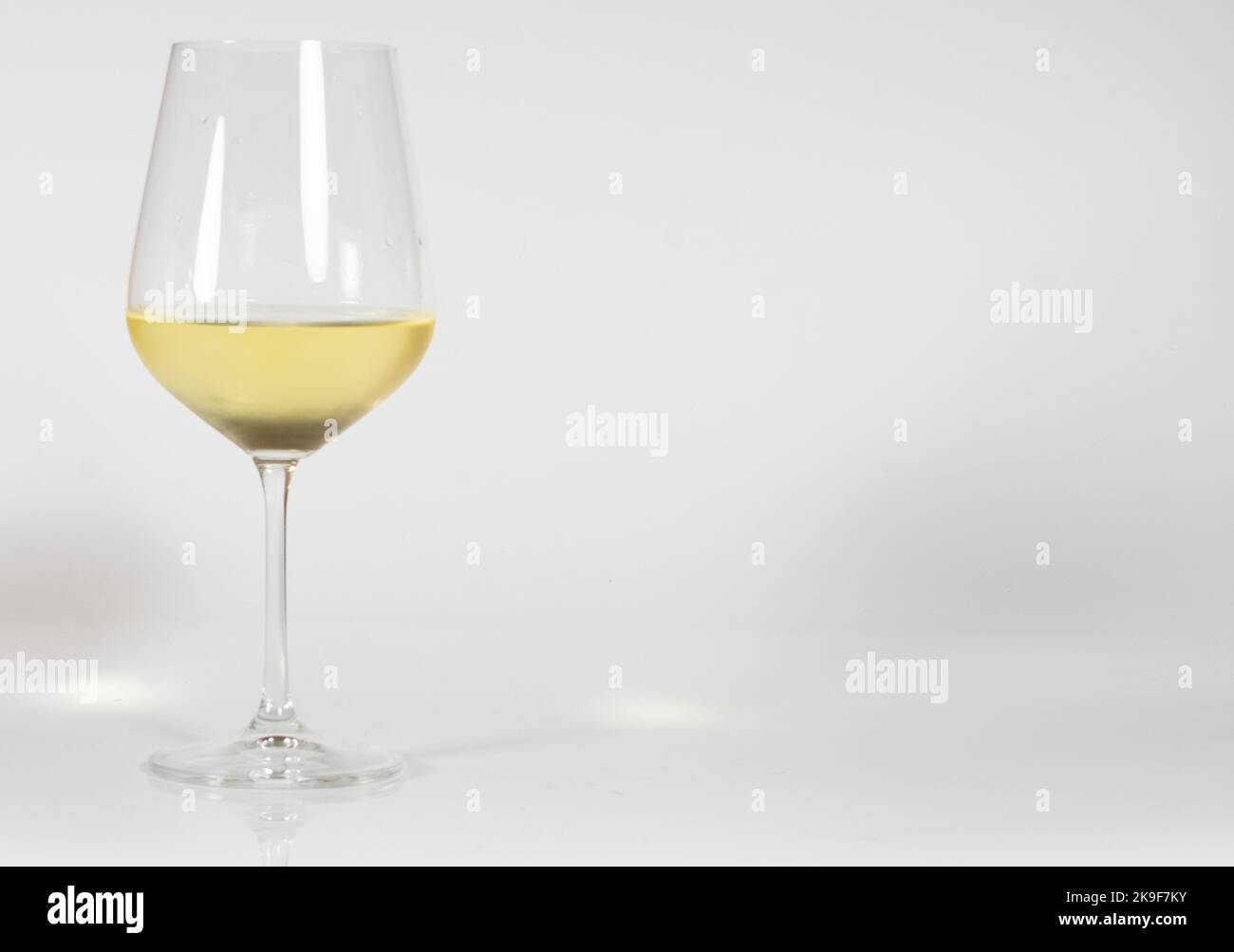 a glass of white wine in white background Stock Photo - Alamy