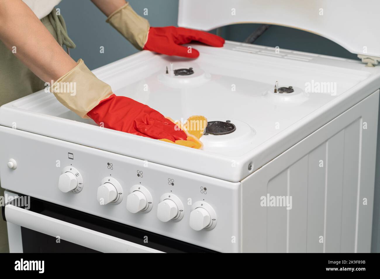 woman washing a gas stove with a rag. High quality photo Stock Photo ...