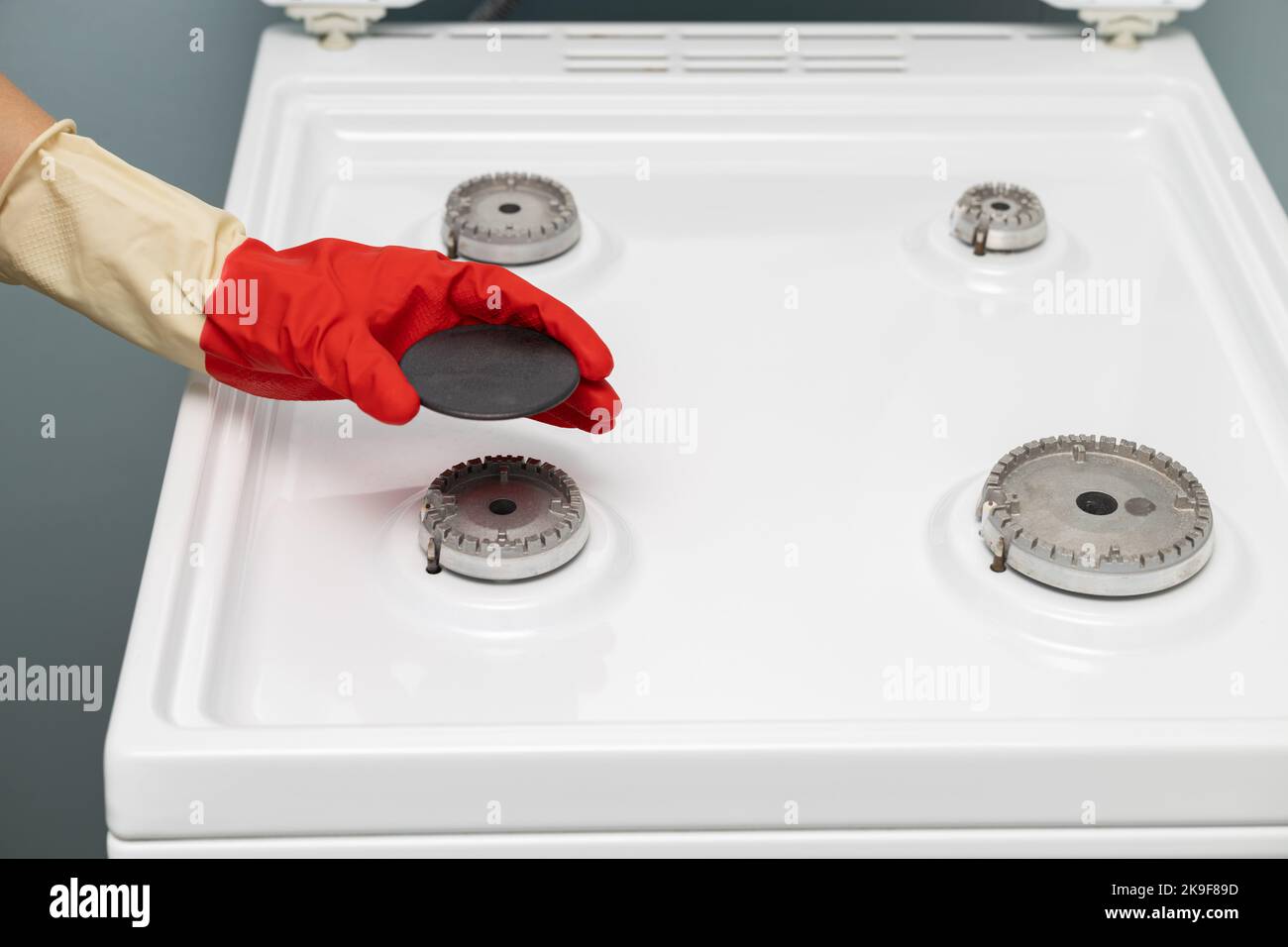 man washing a gas stove with a rag. assembling gas burner Stock Photo ...