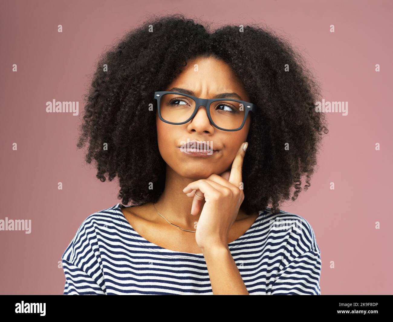 Just thinking about life. a beautiful young woman looking thoughtful ...