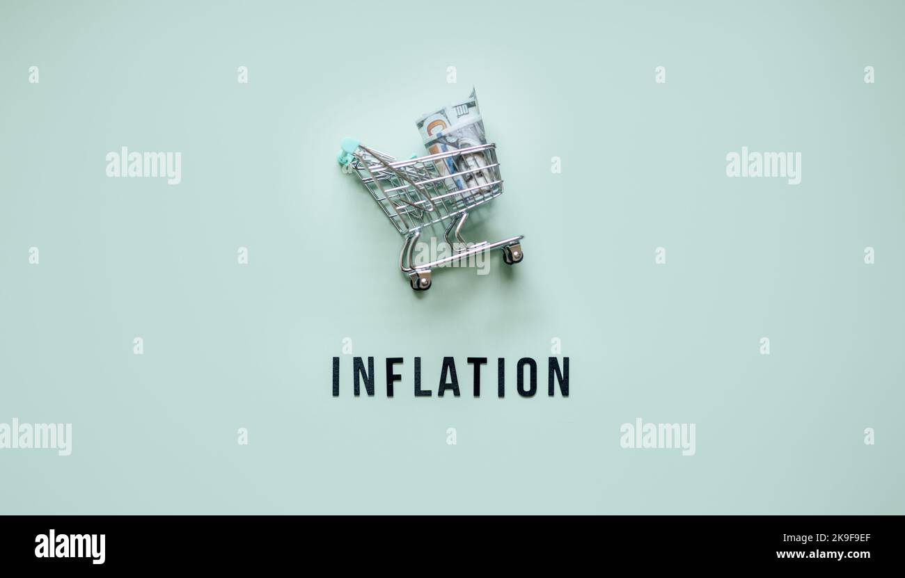 Shopping basket cart with dollars cash and word Inflation on blue ...