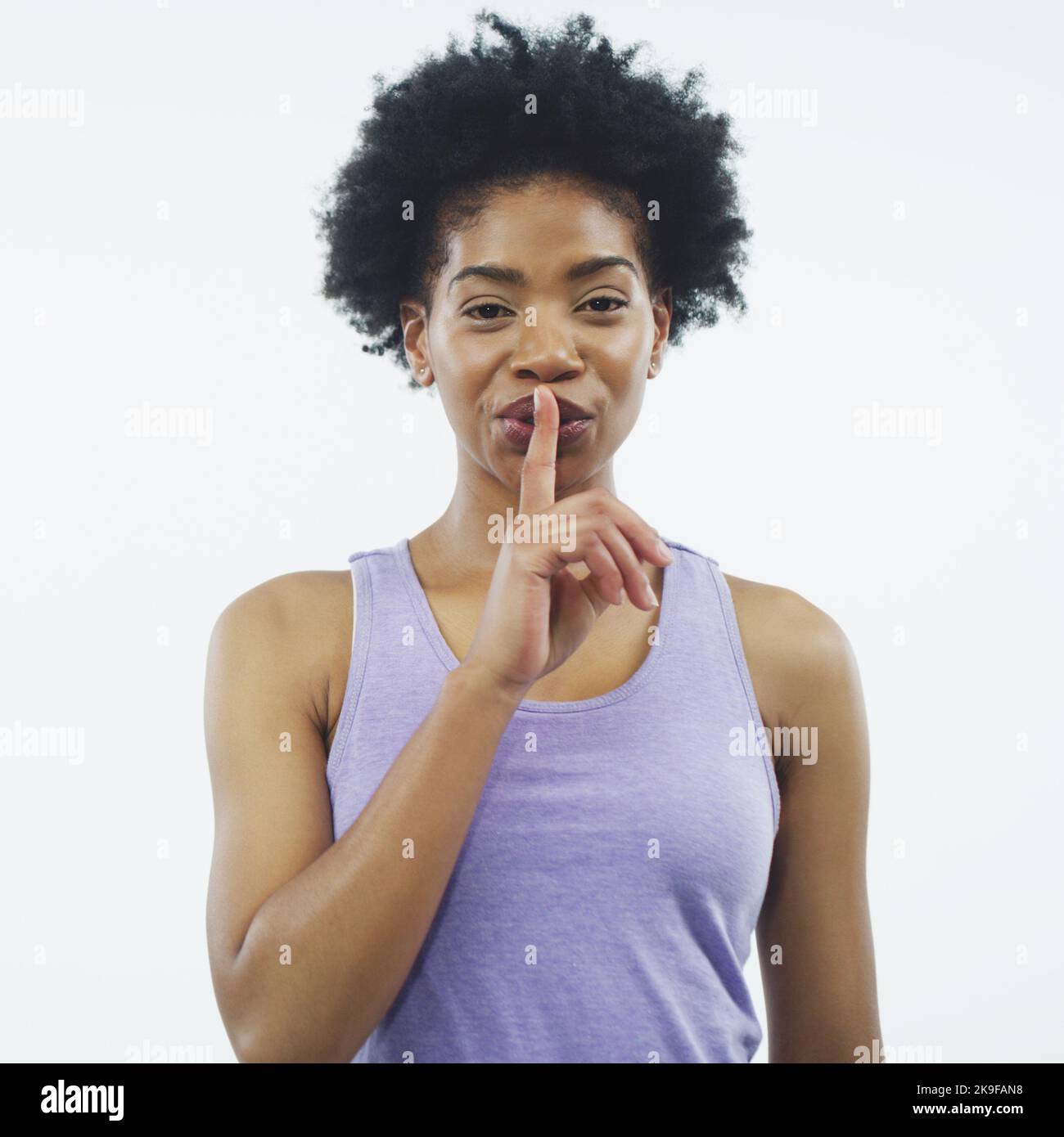 Can you keep a secret. Studio shot of an attractive young woman posing ...
