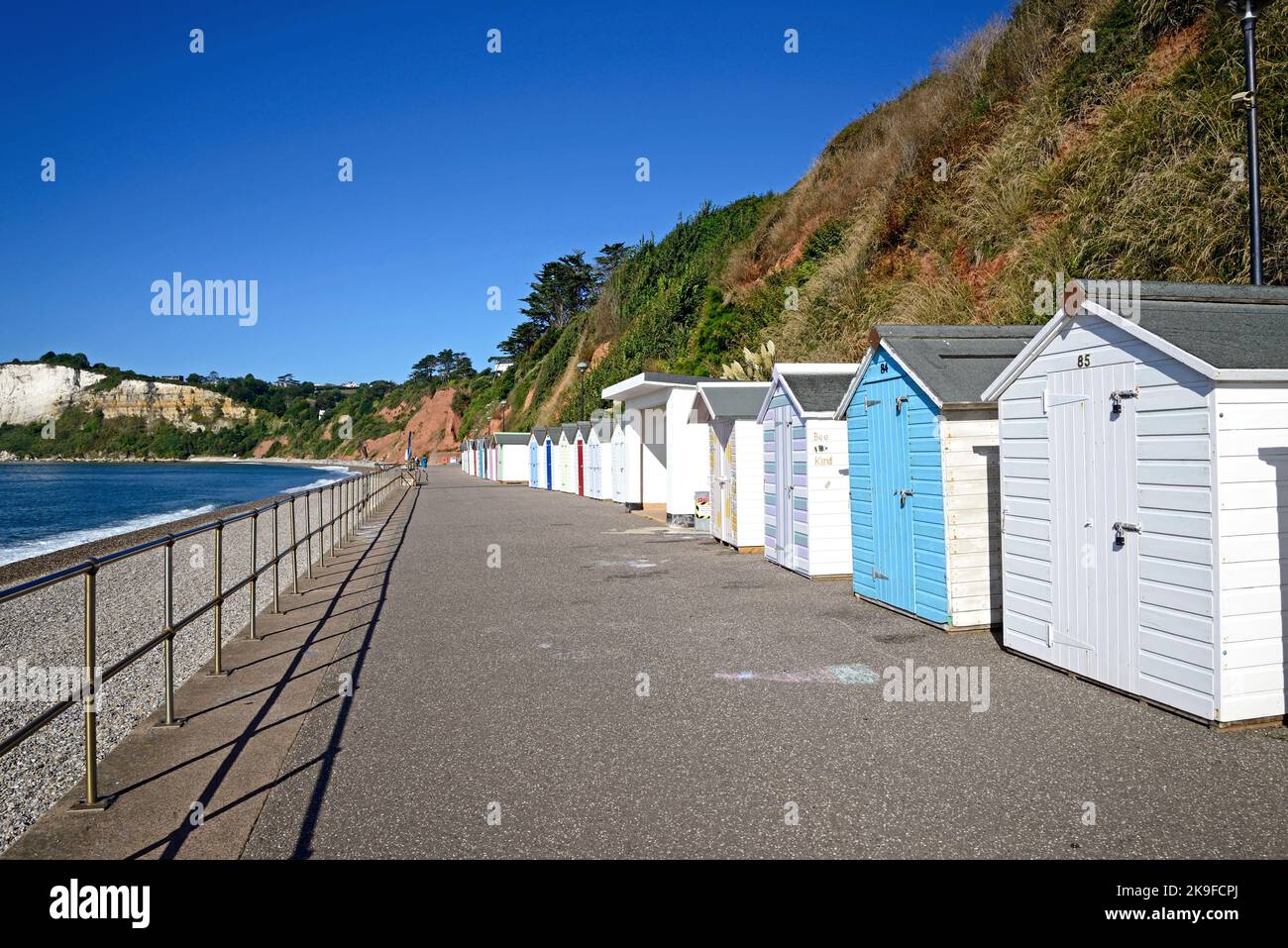 Beach huts alongside the beach with views towards Beer Head, Seaton ...