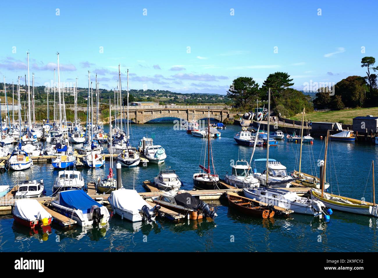 Bridge across the River Axe with small fishing boats and yachts in the ...