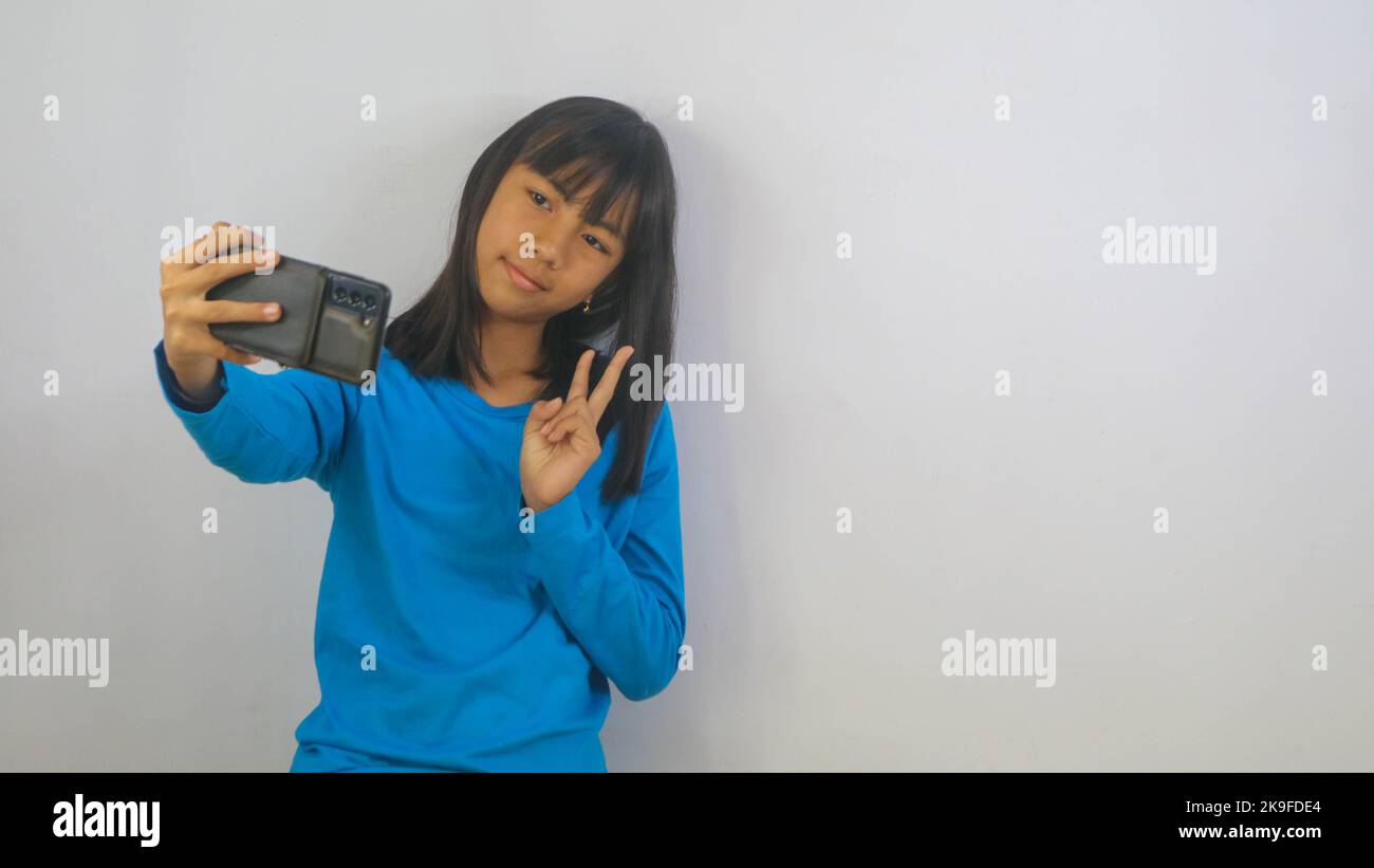 a little girl mixed european asia in blue shirt isolated on white ...