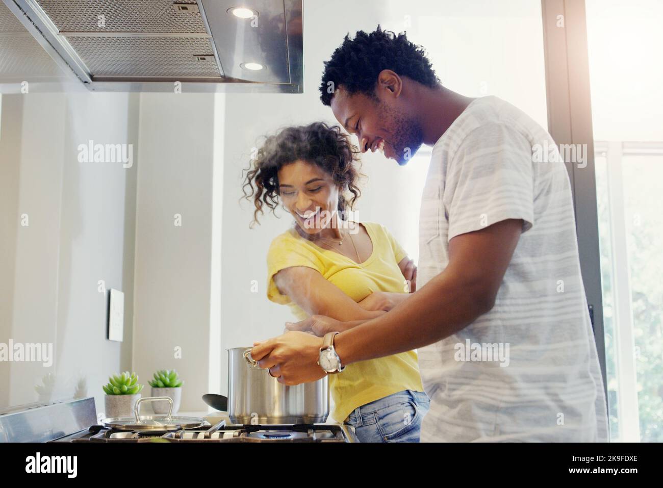 Its getting hot in here. a young couple cooking together in the kitchen ...