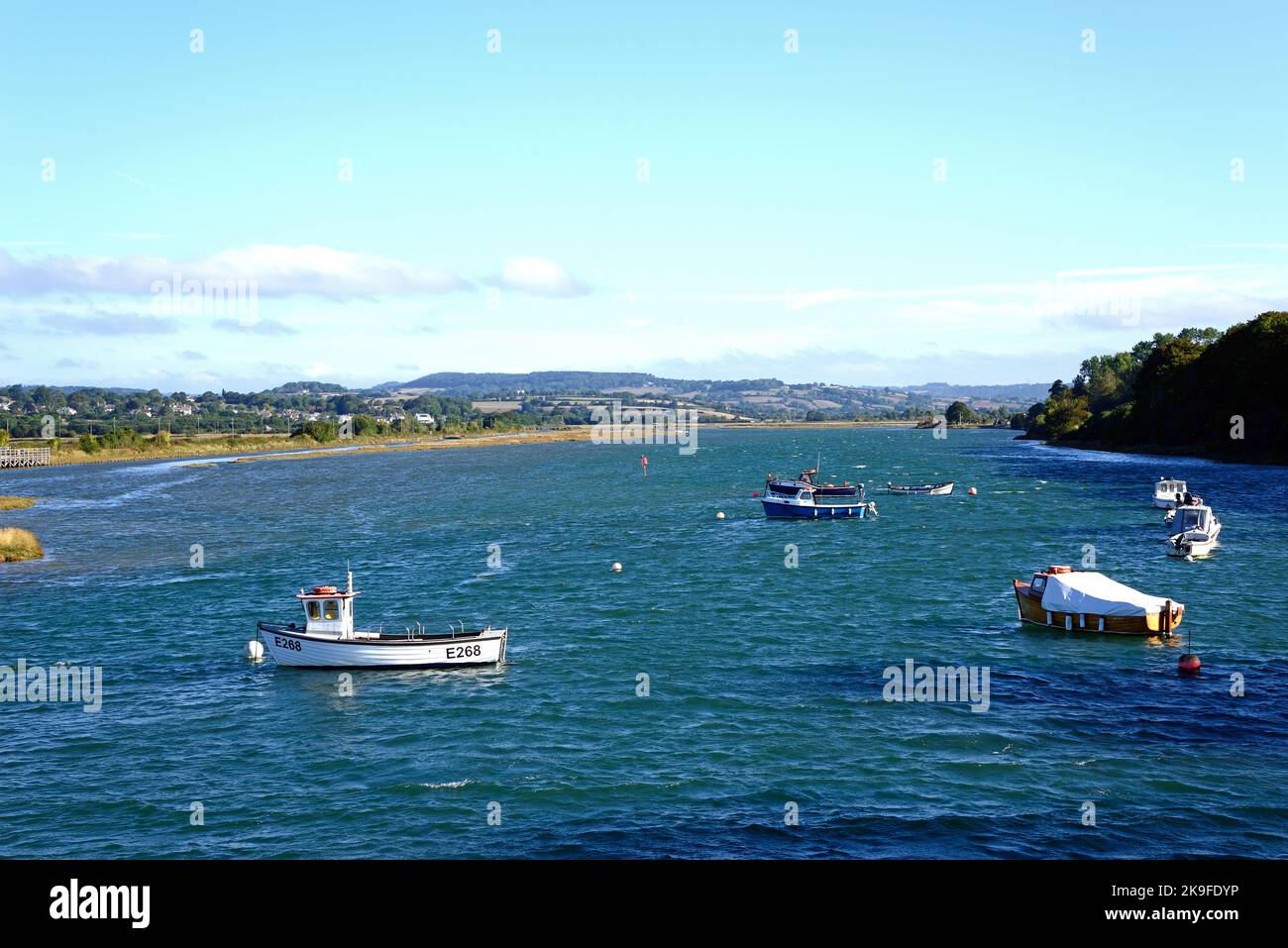 Small fishing boats moored along the River Axe with the Devon ...