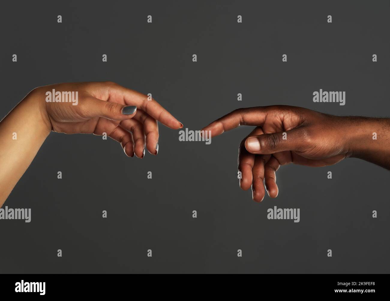 It only takes one touch. Studio shot of two unrecognizable people ...