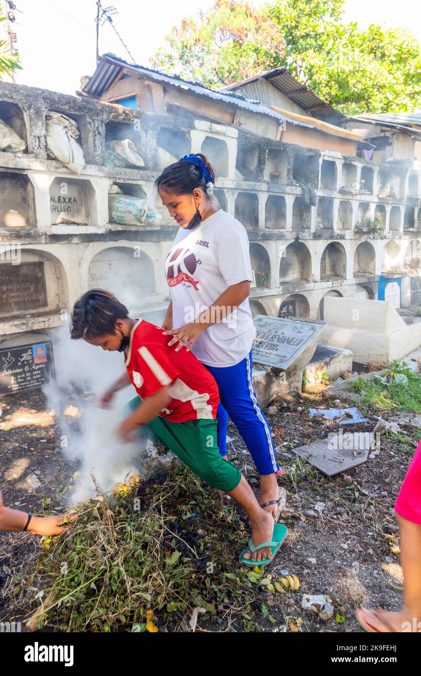 A cemetery ritual smoking in Cebu, Philippines Stock Photo - Alamy