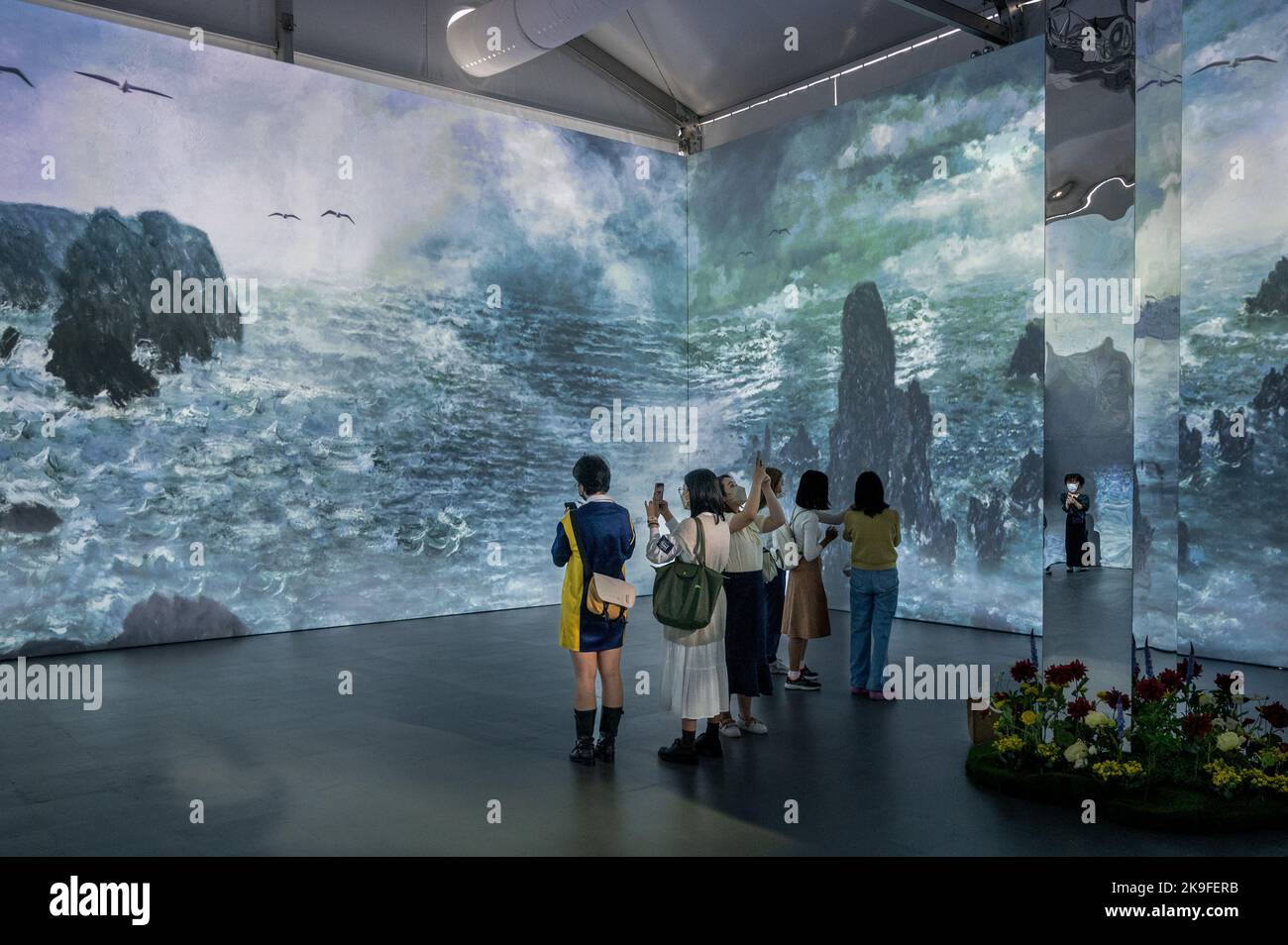 Visitors are seen at the exhibition 'En Voyage with Claude Monet' which ...