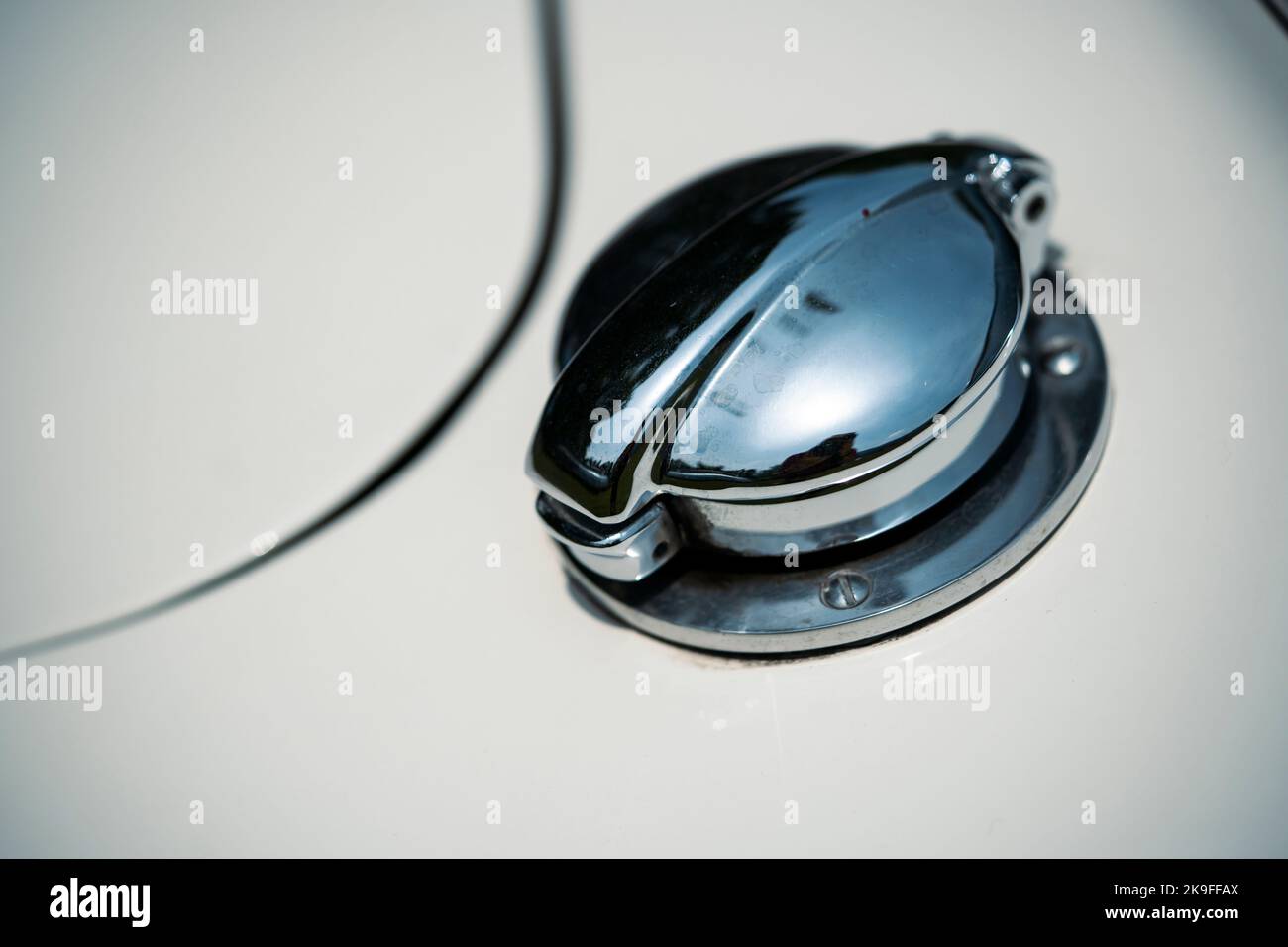 Fuel tank cap with key slot on white vintage car or bus Stock Photo - Alamy