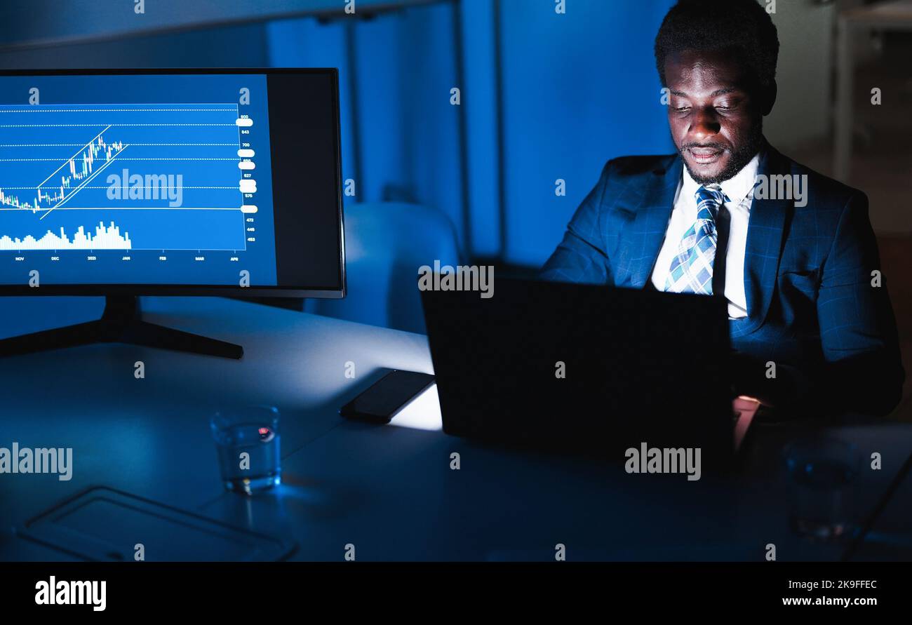 African trader studying stock market at home - Focus on face Stock ...