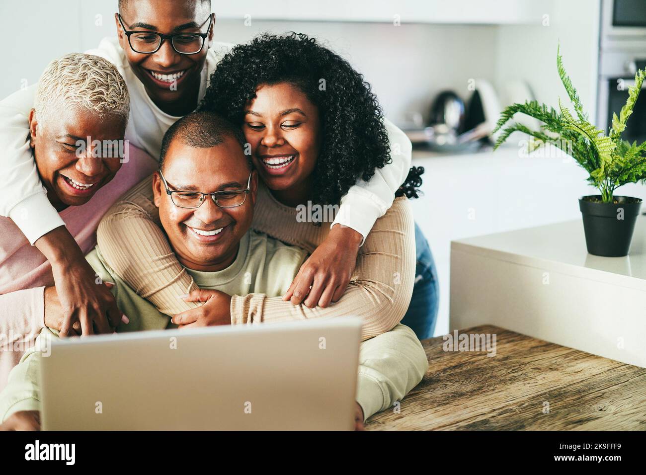 Happy black family doing video call at home - Main focus on father face ...