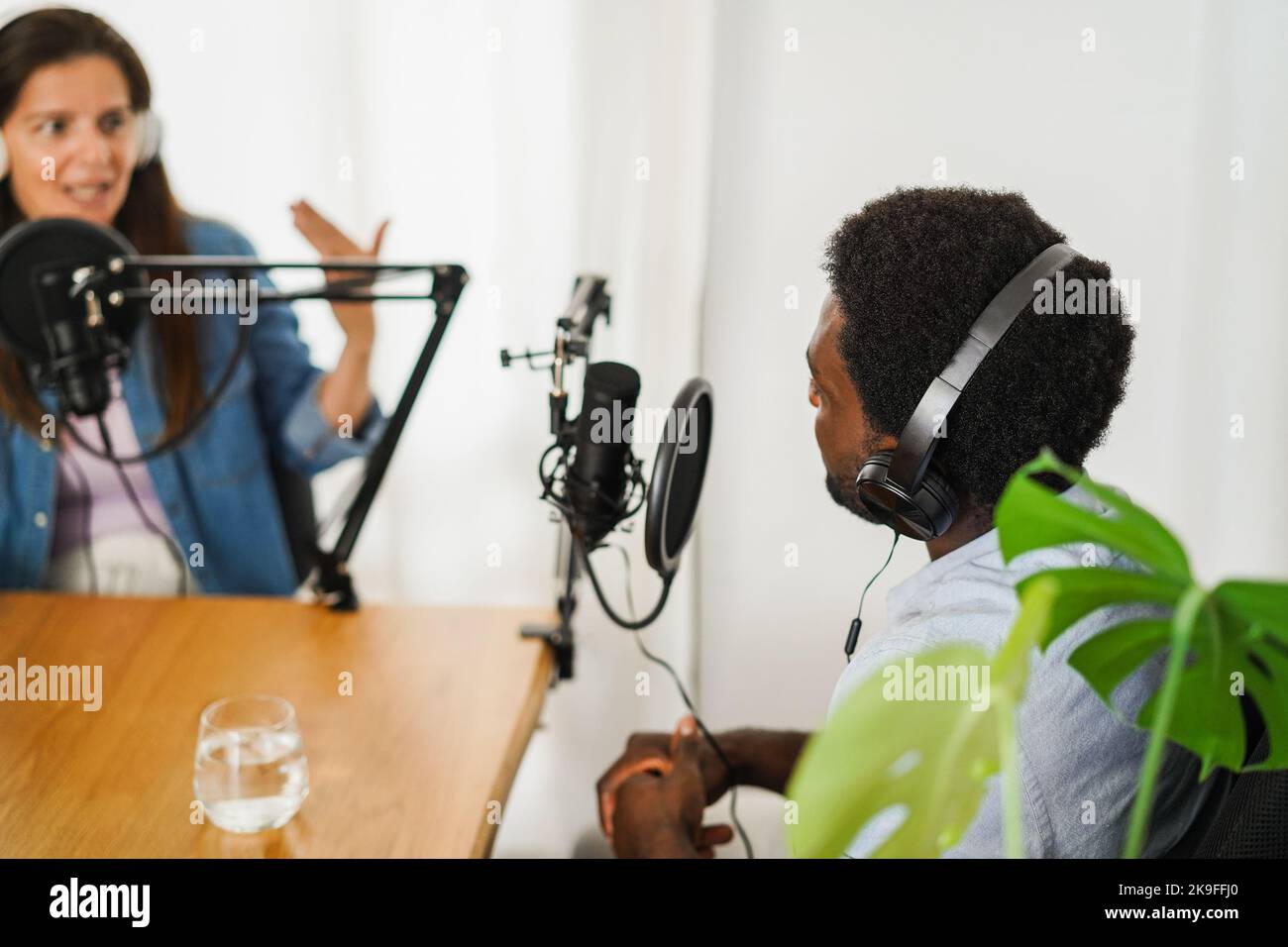 Hosts having podcast session together - Female speaker making an ...