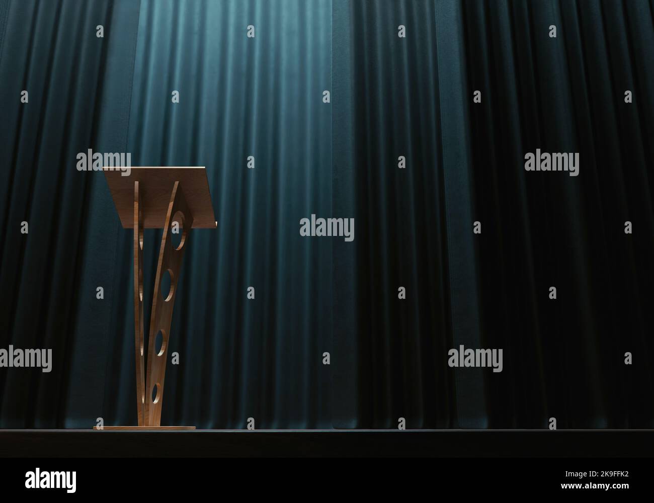 A wooden speech podium with small microphones on a dark curtained stage ...
